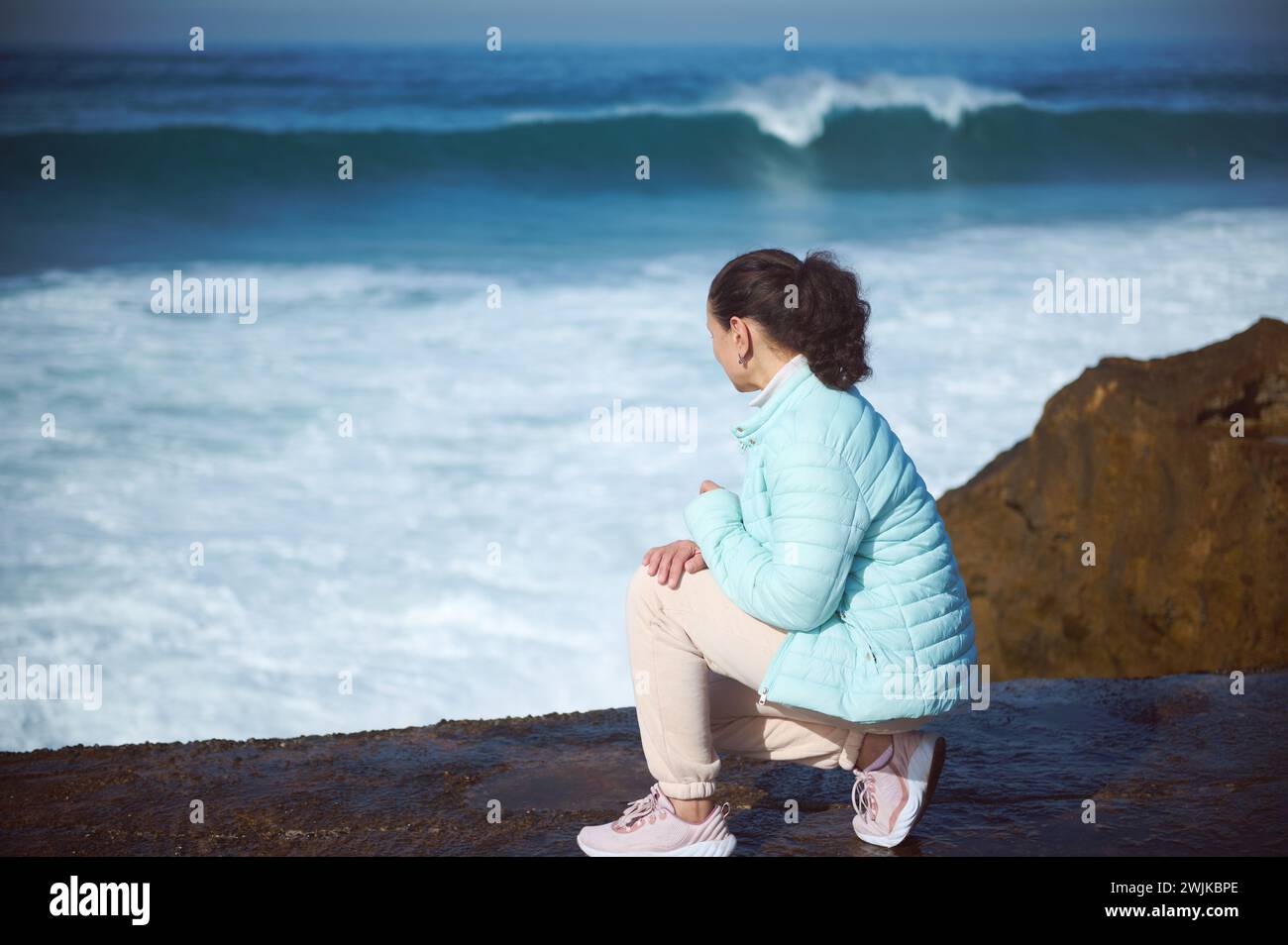 Rear view of a woman, adventurer traveler tourist looking into the ...