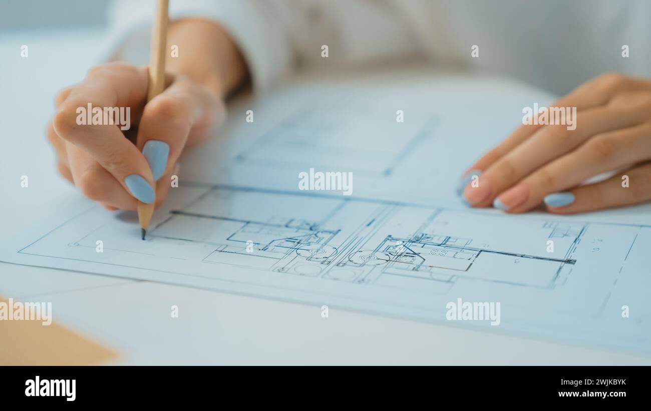 Closeup of professional caucasian female engineer hand drawing ...