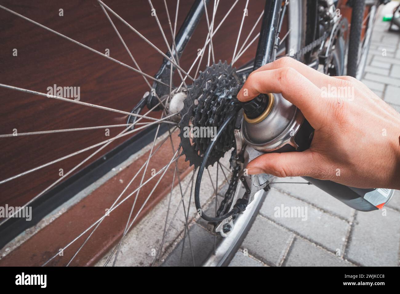 Man prepares his road bike for the season. Cleaning and lubricating a ...