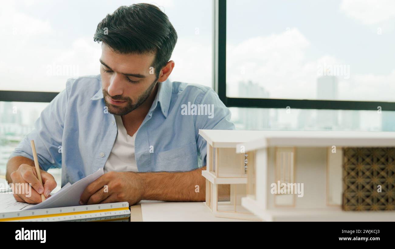 Portrait of caucasian architect engineer designs real estate on ...