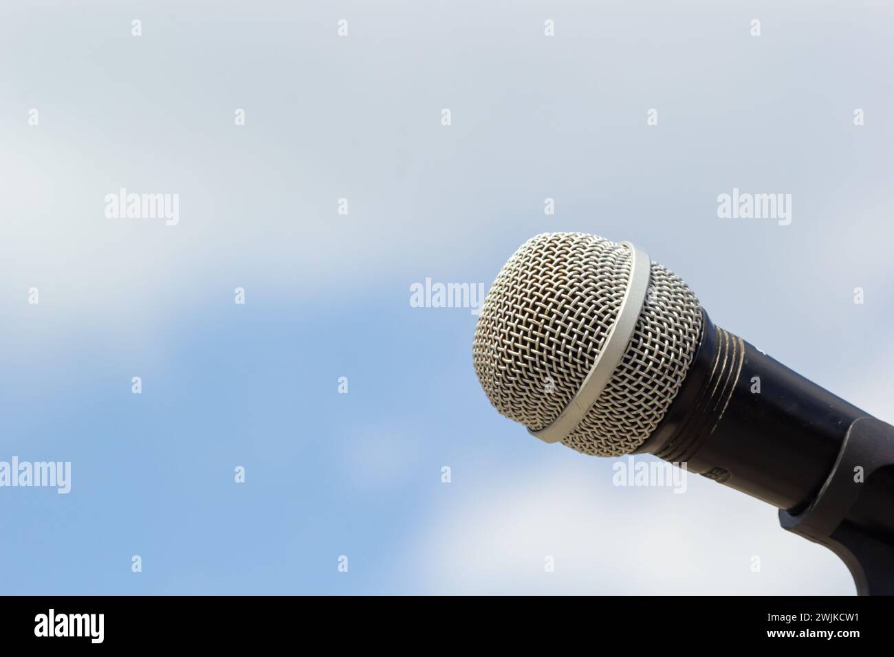 Microphone on sky background. The microphone is on the street. Concept ...