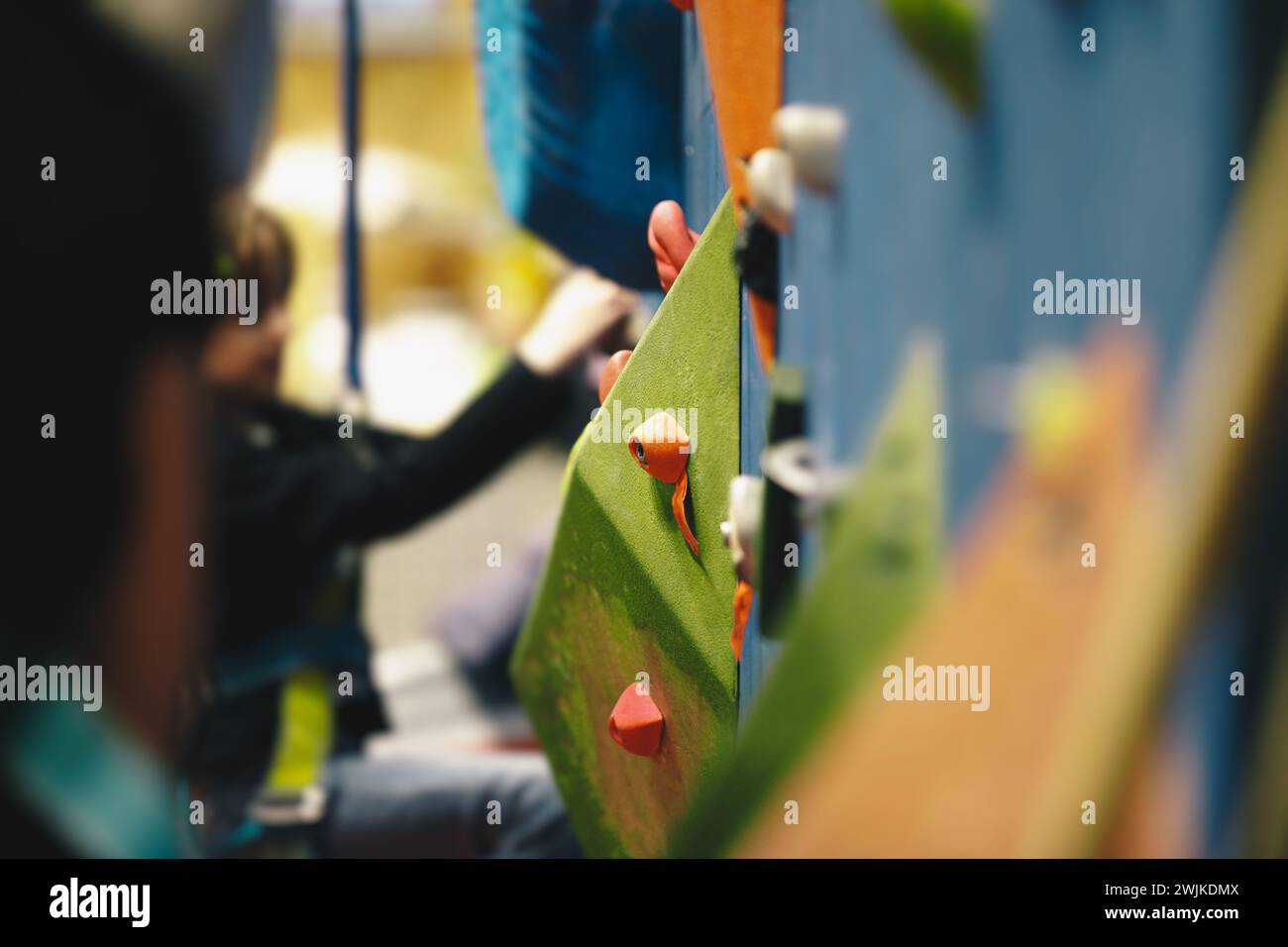 Bouldering climbing wall. Children practicing climbing during indoor ...