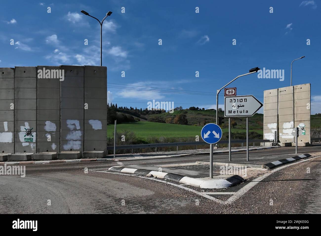 Security walls are placed on the way to the town of Metula situated ...