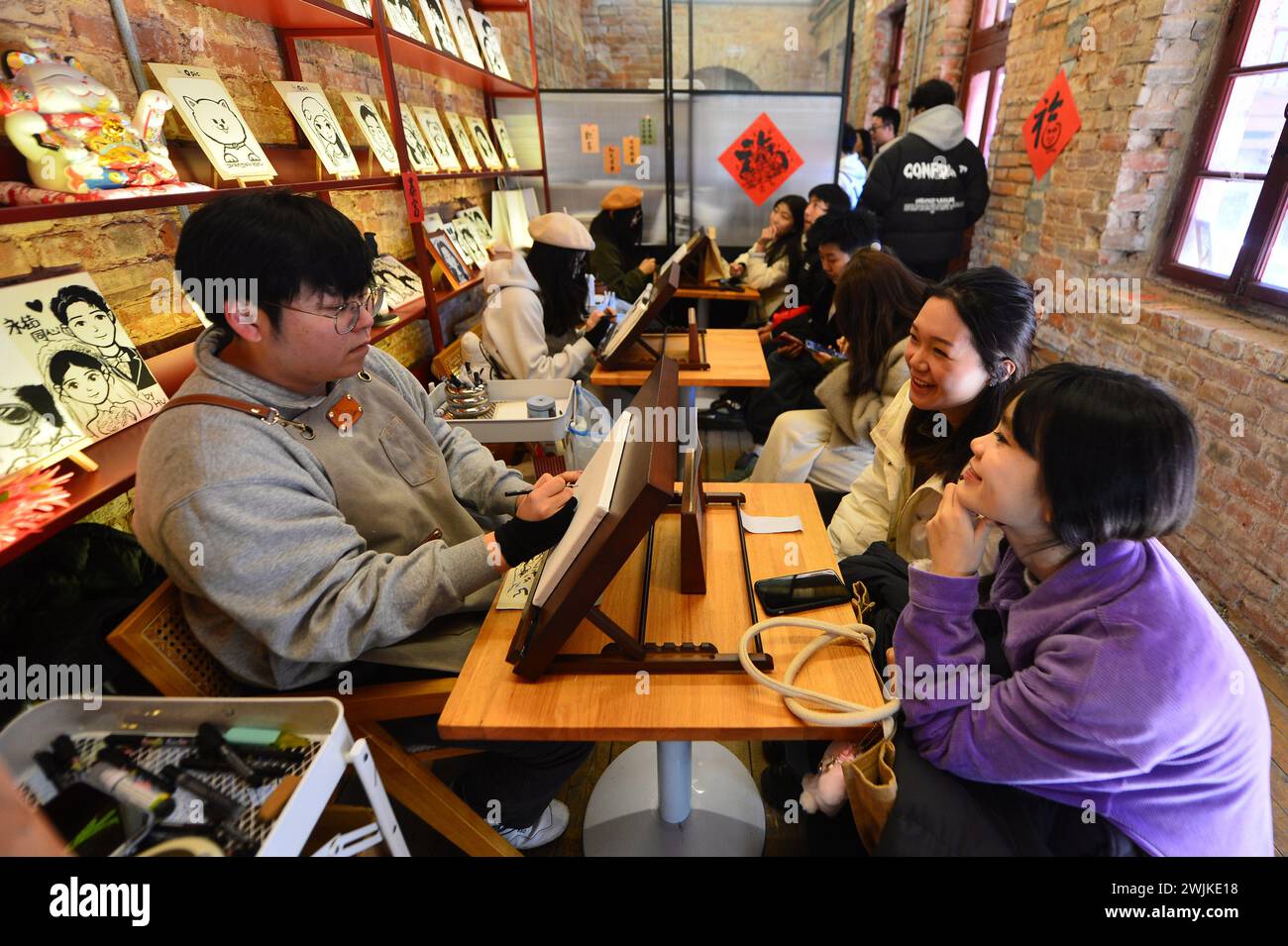 QINGDAO, CHINA - FEBRUARY 16, 2024 - A group of young people paint ...