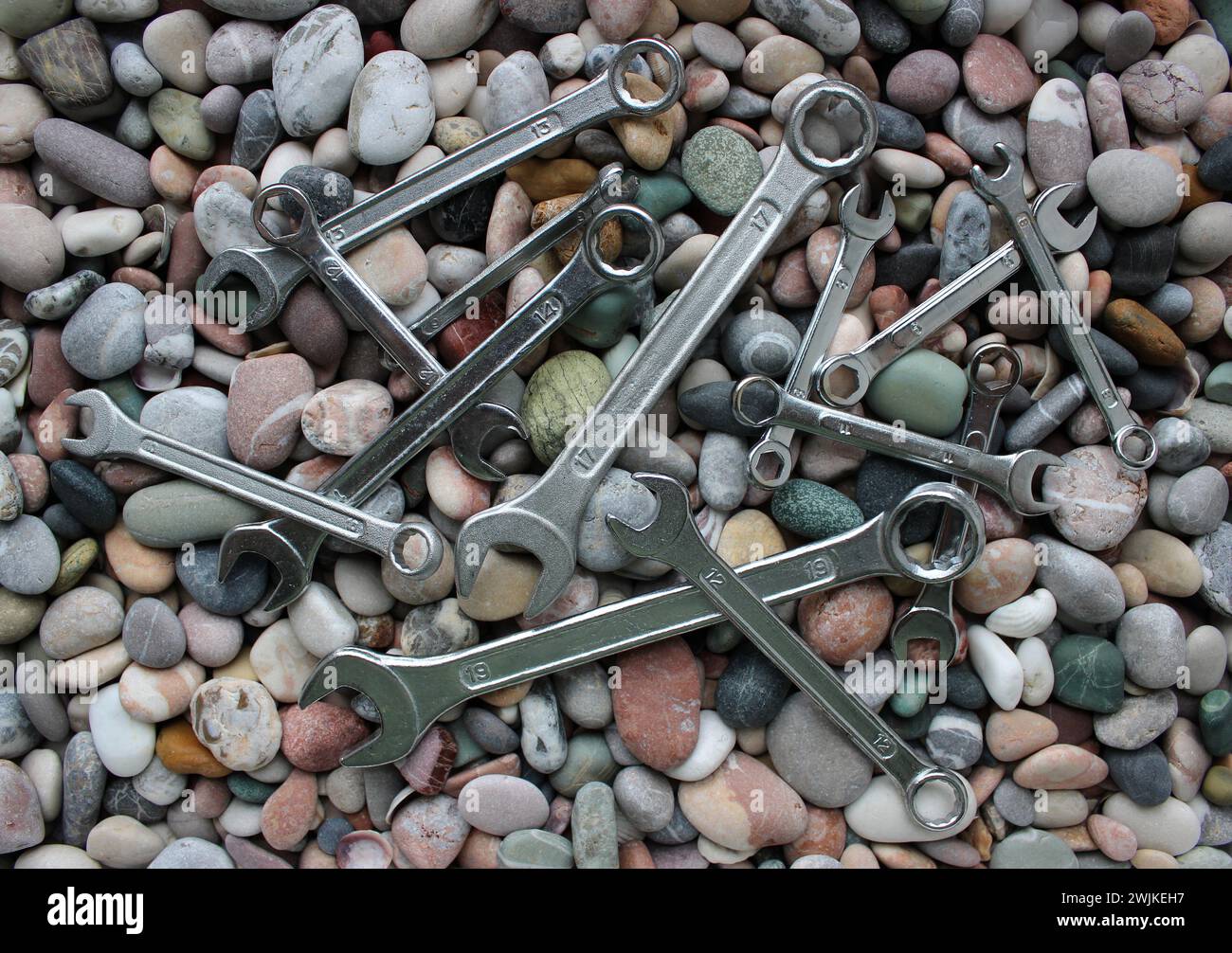 Mechanical wrenches of different sizes lying in disarray on stones ...
