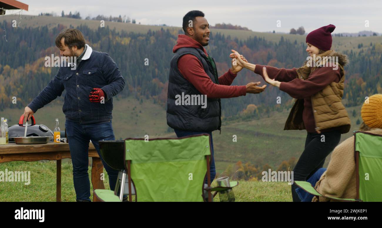 Multi ethnic family together cook food on grill and dance on beautiful ...