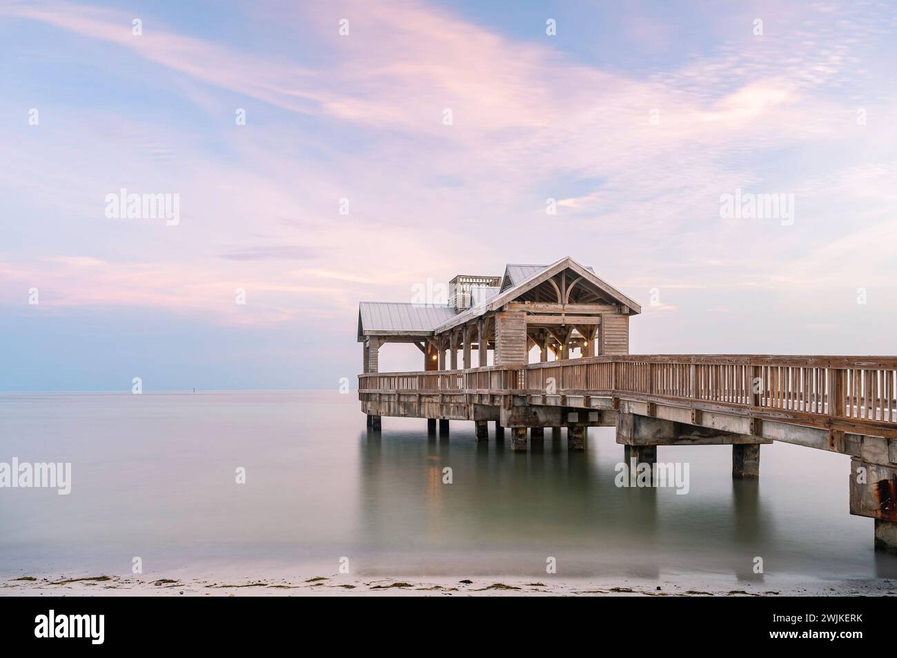 Wooden pier, located in Key West, Florida, reaching out into very calm ...