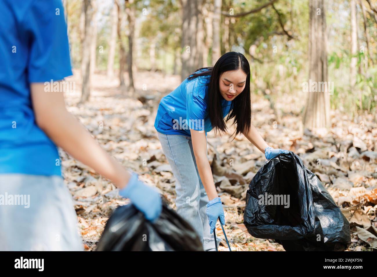 Group of volunteers, community members cleaning the nature from garbage ...
