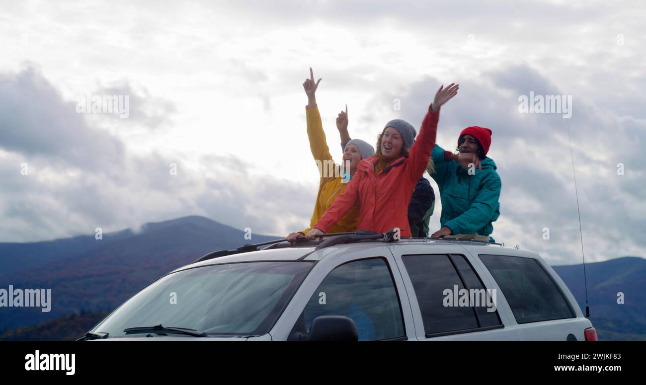 Group of diverse tourists together ride on vacation in mountains ...