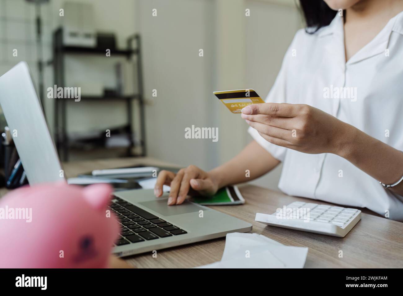 young woman checking bills, taxes, bank account balance and calculating ...