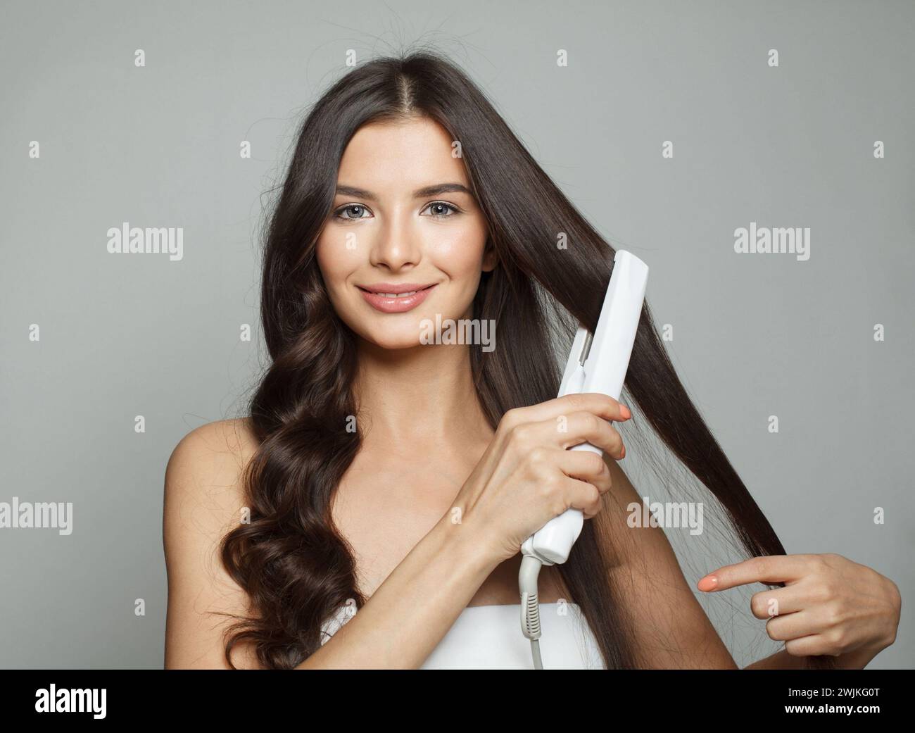 Straightening irons woman hi-res stock photography and images - Alamy