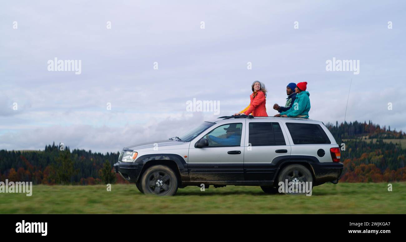 Group of diverse tourists together ride on vacation in mountains ...