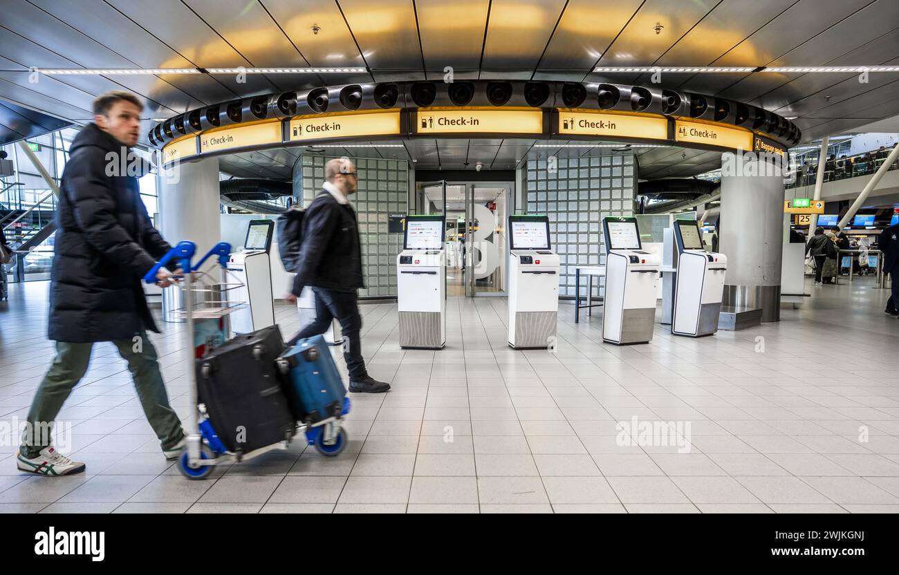 SCHIPHOL - Travelers in the departure hall of Schiphol Airport on the ...