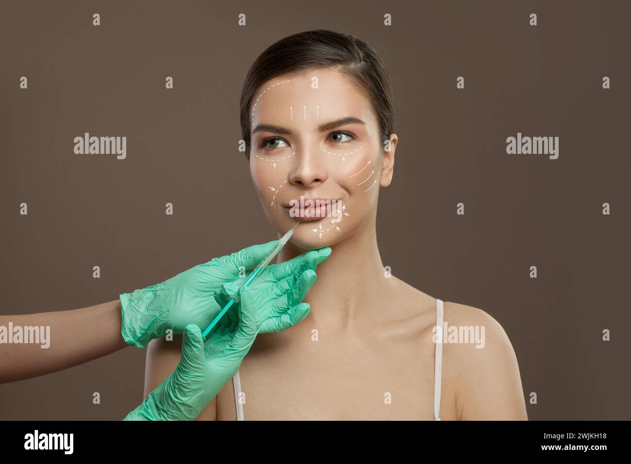 Cheerful woman with arrow lines on her face for lifting skin and ...