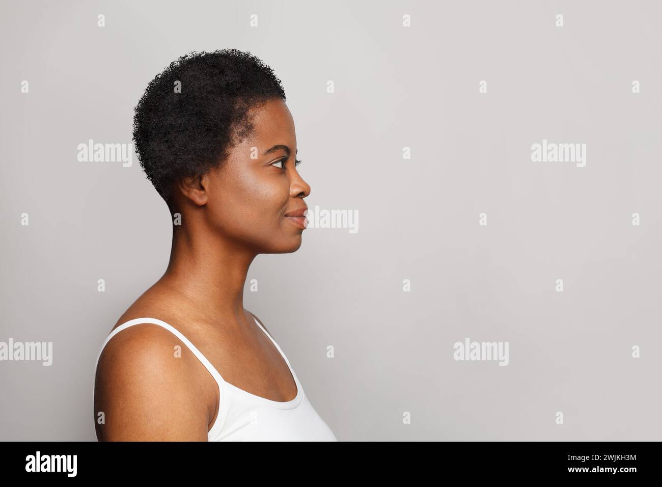 Female profile of healthy young woman with dark shiny skin smiling on ...