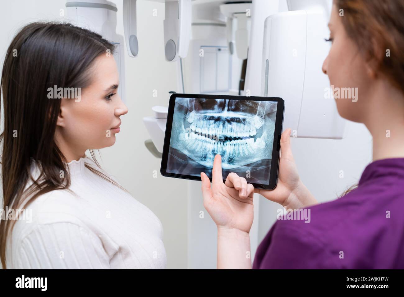 Dentist Presenting Jaw and Teeth Radiograph x ray to Patient in Dental ...