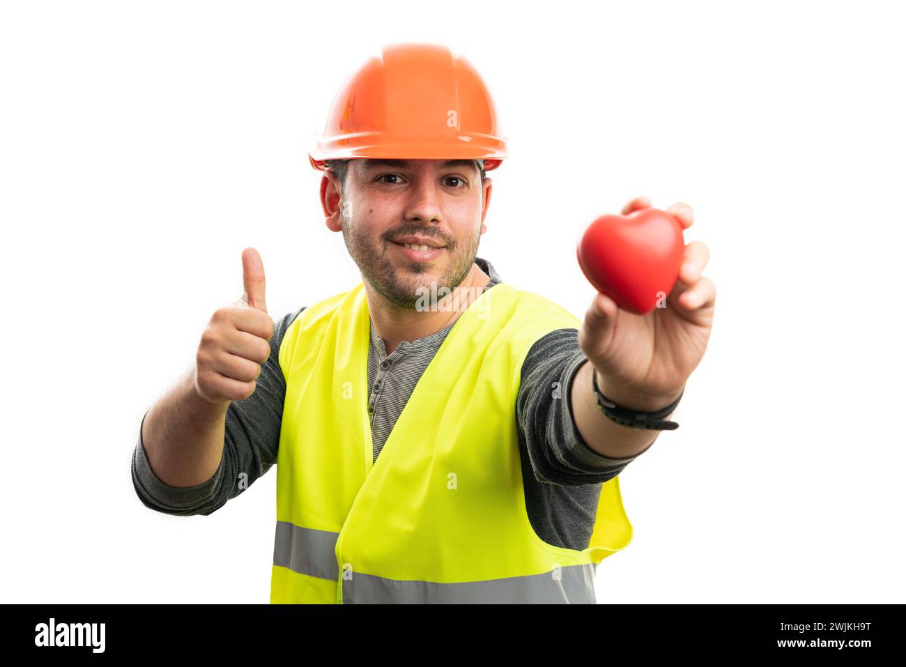 Cheerful smiling builder man presenting red heart making thumb-up like ...