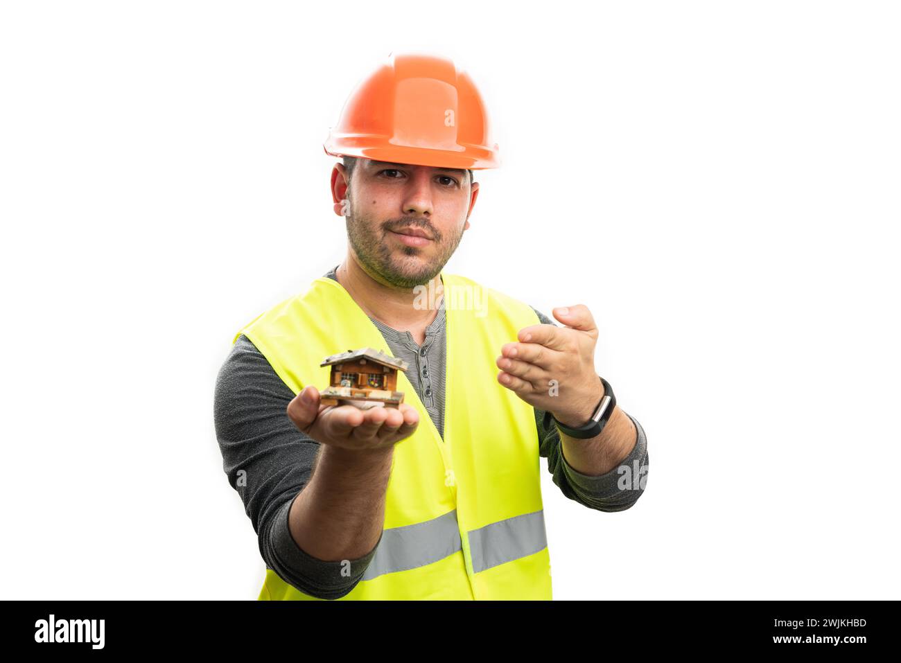 Friendly constructor man wearing vest and safety helmet presenting ...