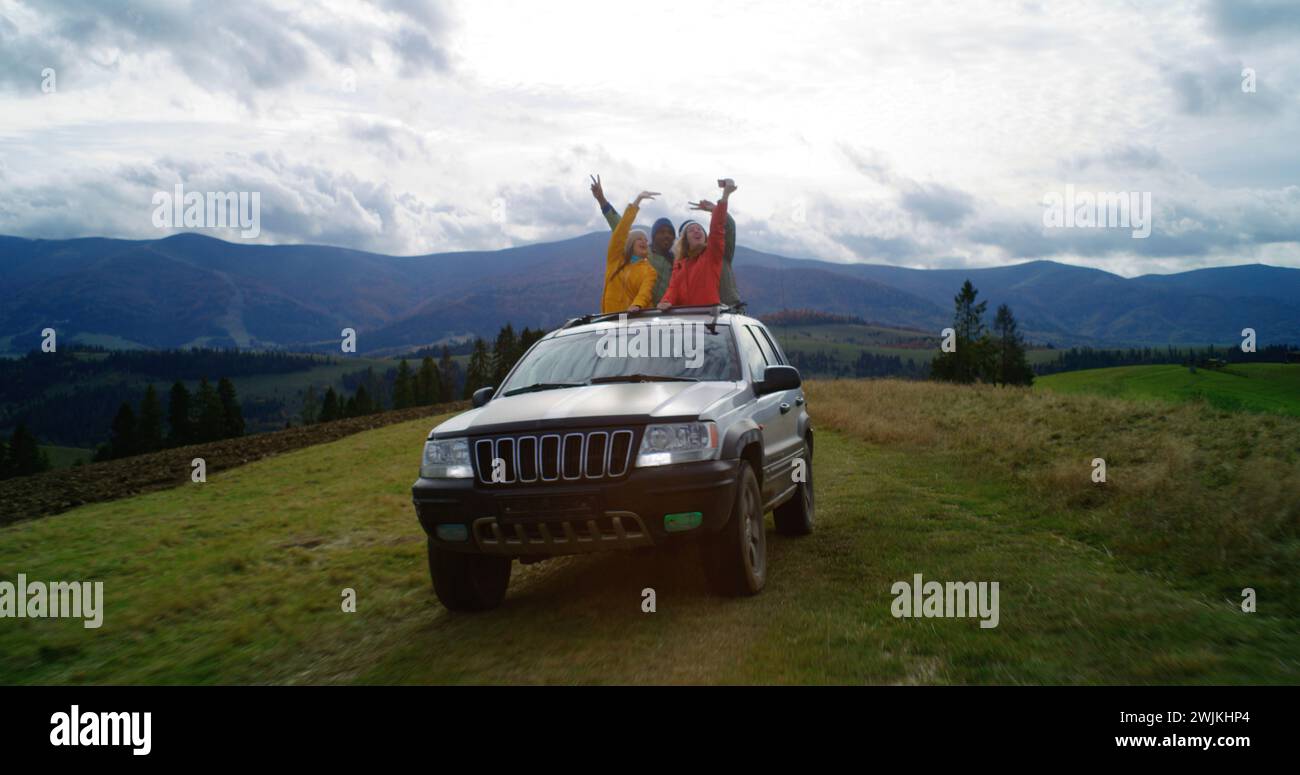 Group of multiethnic tourists together ride on vacation in mountains ...