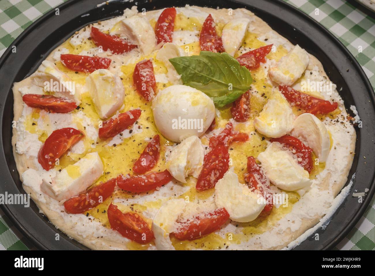 Homemade Pizza With Mozzarella And Tomatoes Before Baking Stock Photo ...