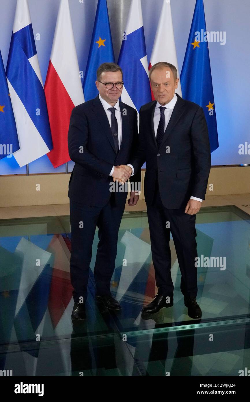 Polish Prime Minister Donald Tusk, right, shakes hands with Finnish ...