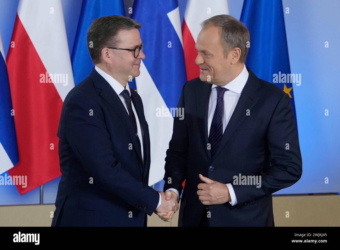 Polish Prime Minister Donald Tusk, right, shakes hands with Finnish ...