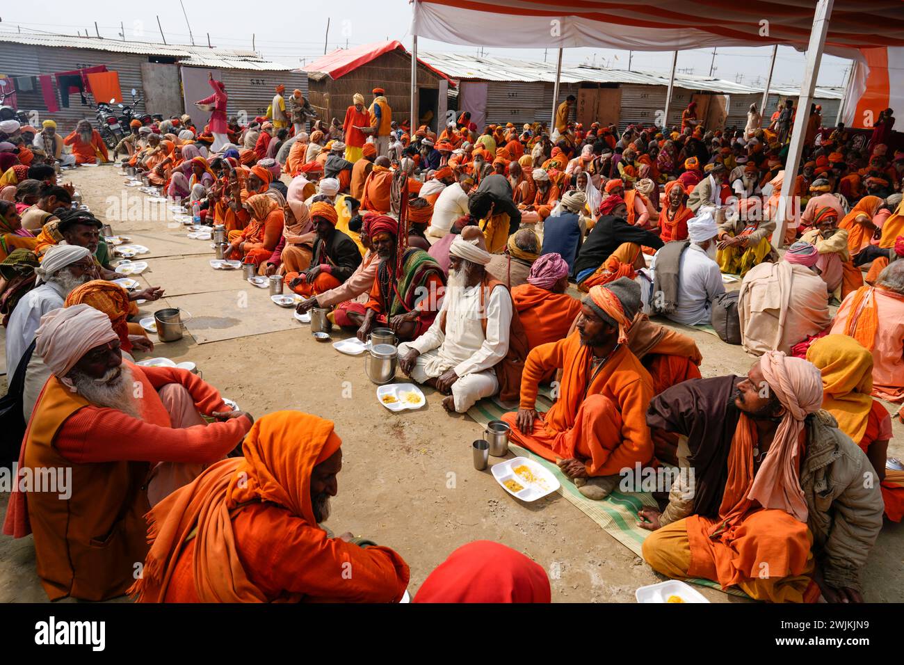 Hindu devotees participate in a community feast at the Sangam, the ...