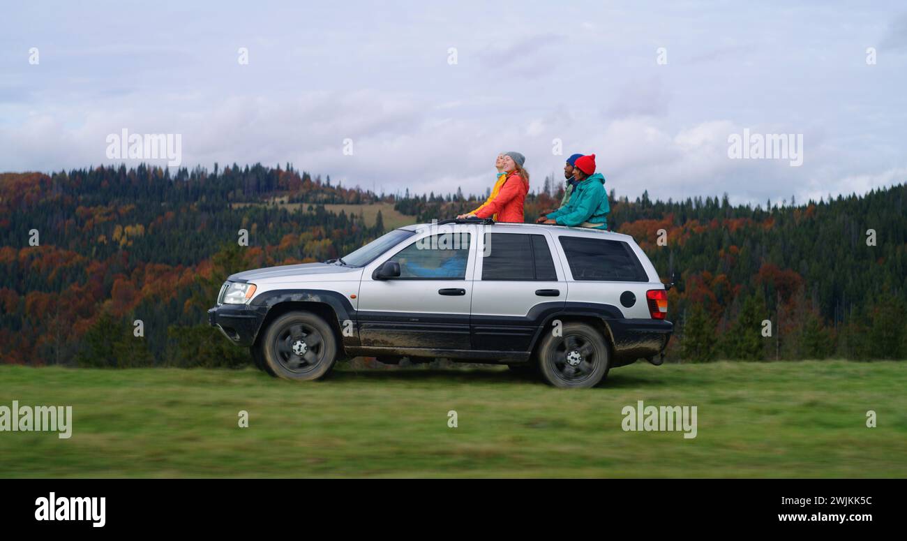 Group of diverse tourists together ride on vacation in mountains ...