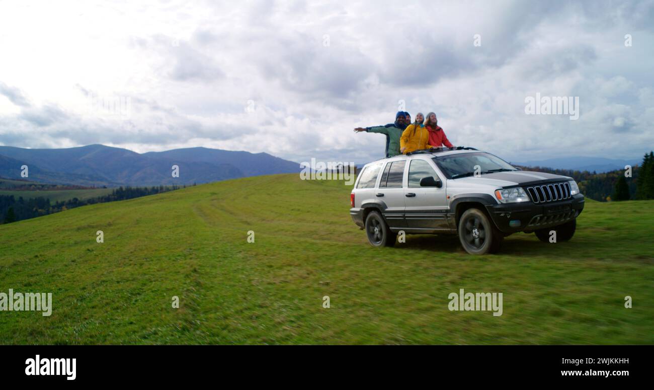Group of multiethnic tourists together ride on vacation in mountains ...