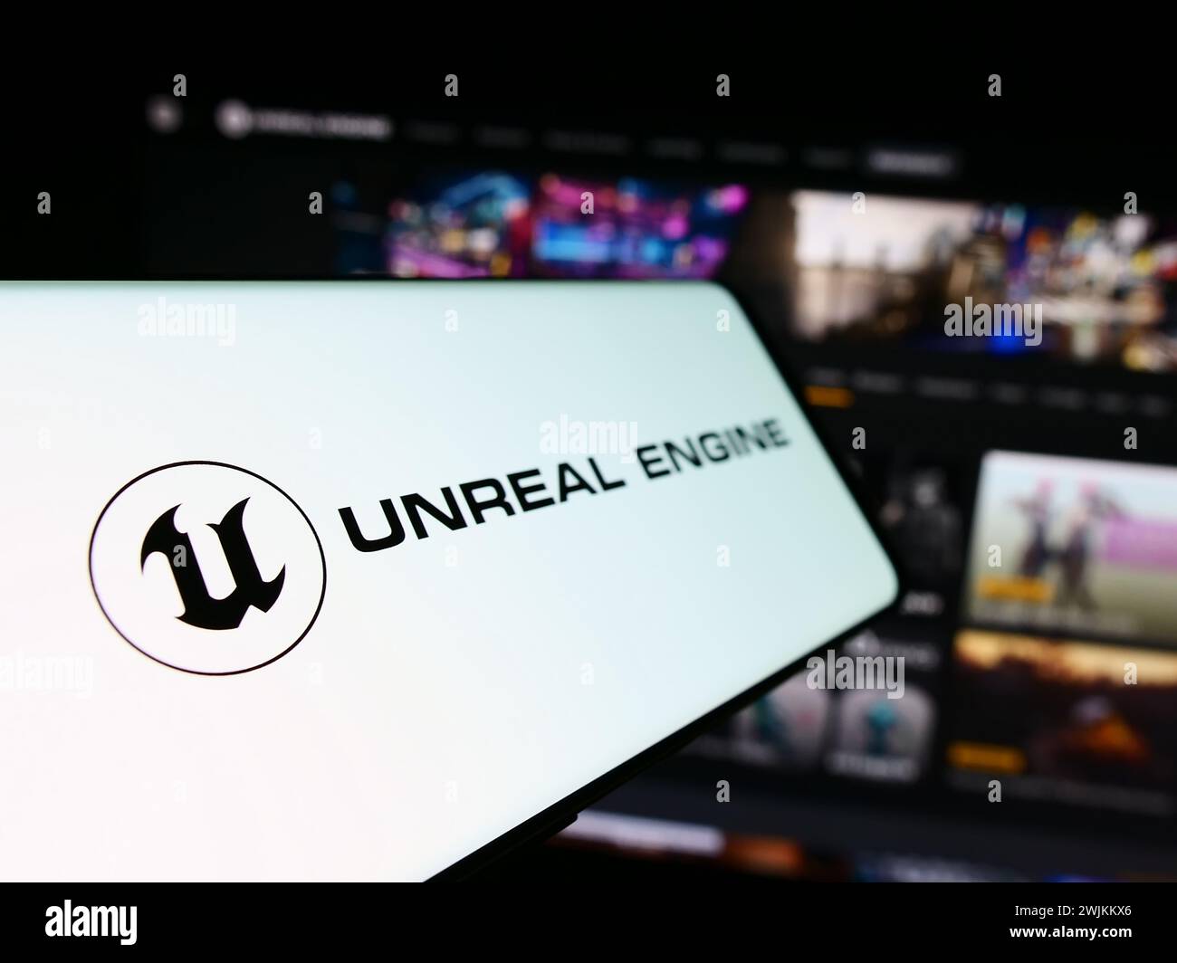 Mobile phone with logo of 3D game software Unreal Engine (Epic Games) in front of business ...