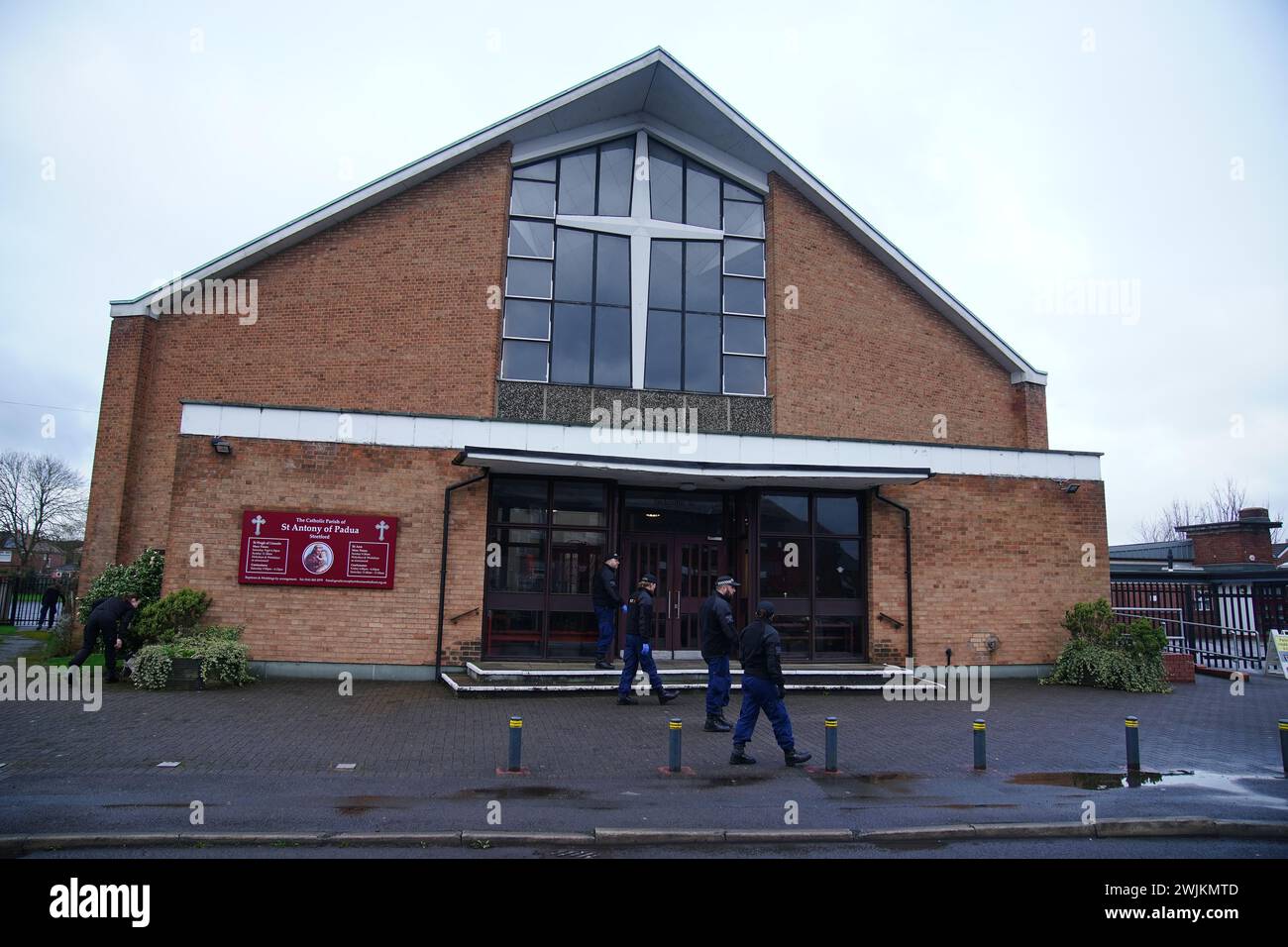 Police officers carry out security sweeps ahead of the Requiem Mass for ...