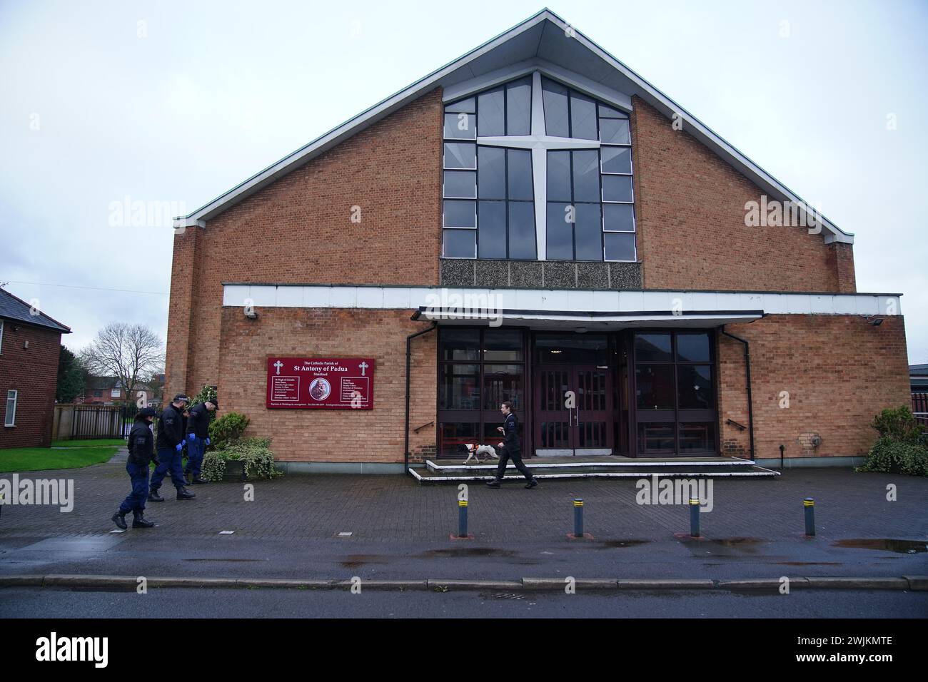Police officers carry out security sweeps ahead of the Requiem Mass for ...