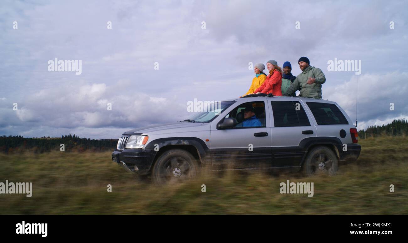 Group of diverse tourists together ride on vacation in mountains ...