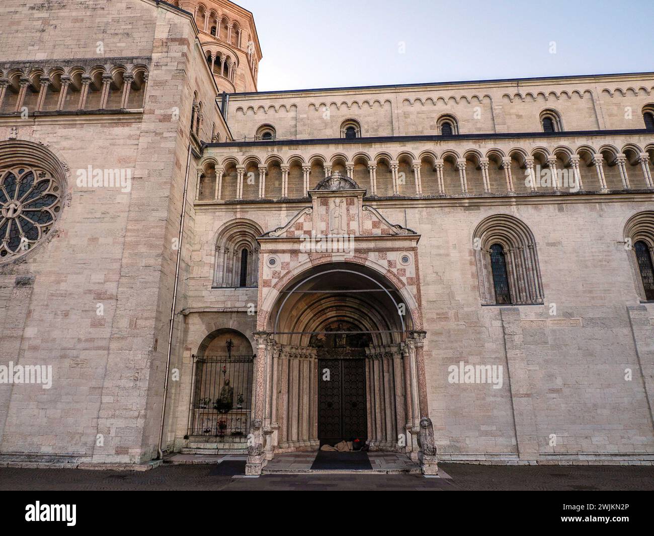 An Homeless tramp sleeping outside entrance of the Medieval Cathedral ...