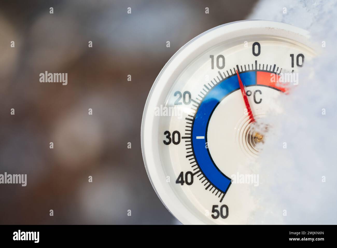 Round thermometer with celsius scale indicating minus 5 degree ambient ...
