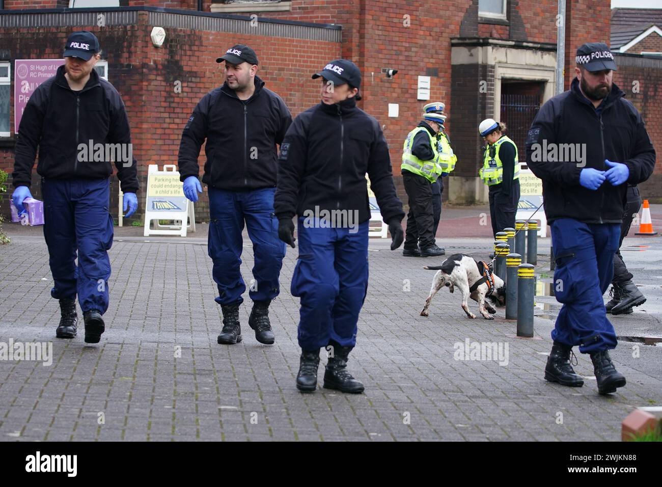 Police officers carry out security sweeps ahead of the Requiem Mass for ...
