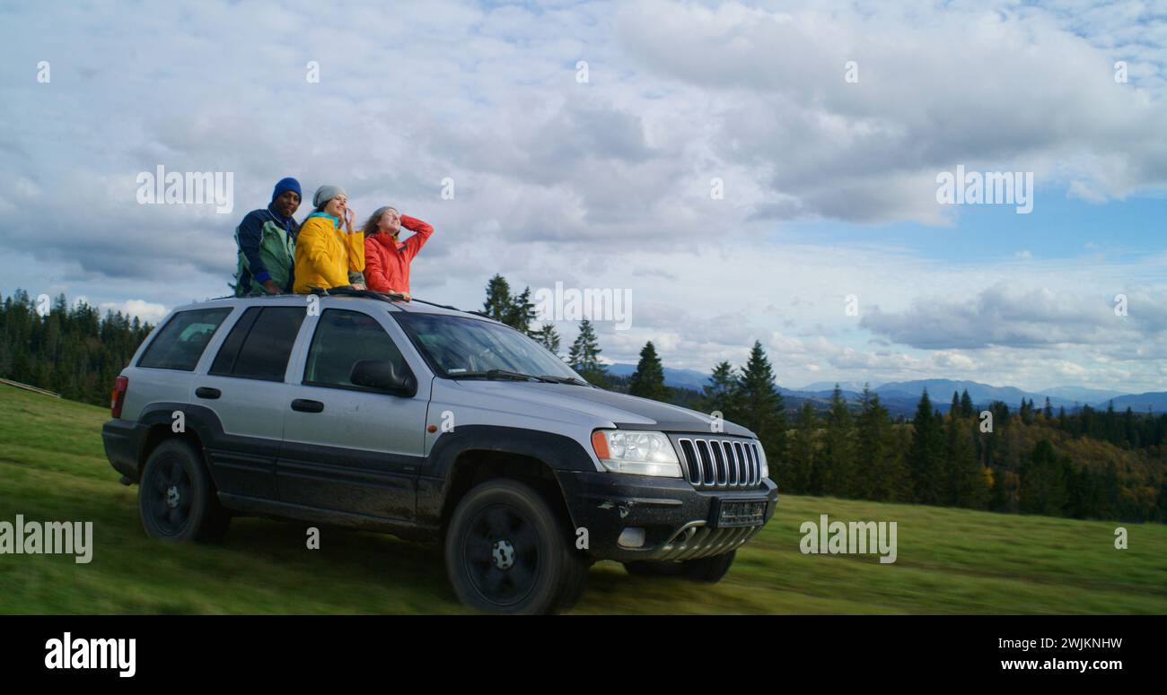 Group of multiethnic tourists together ride on vacation in mountains ...