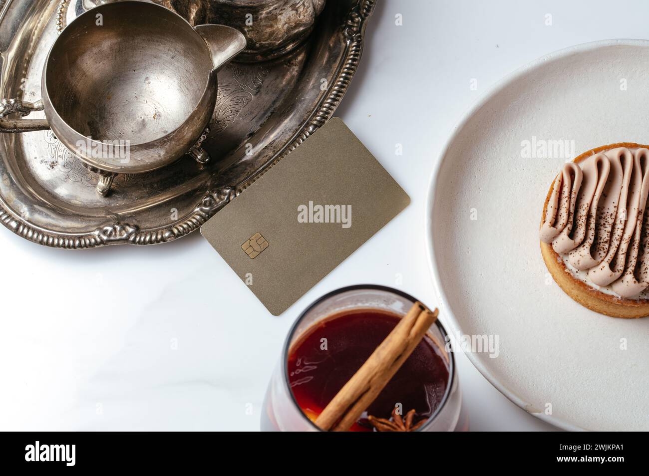 the bank card is on the table in the coffee shop next to the cof Stock ...