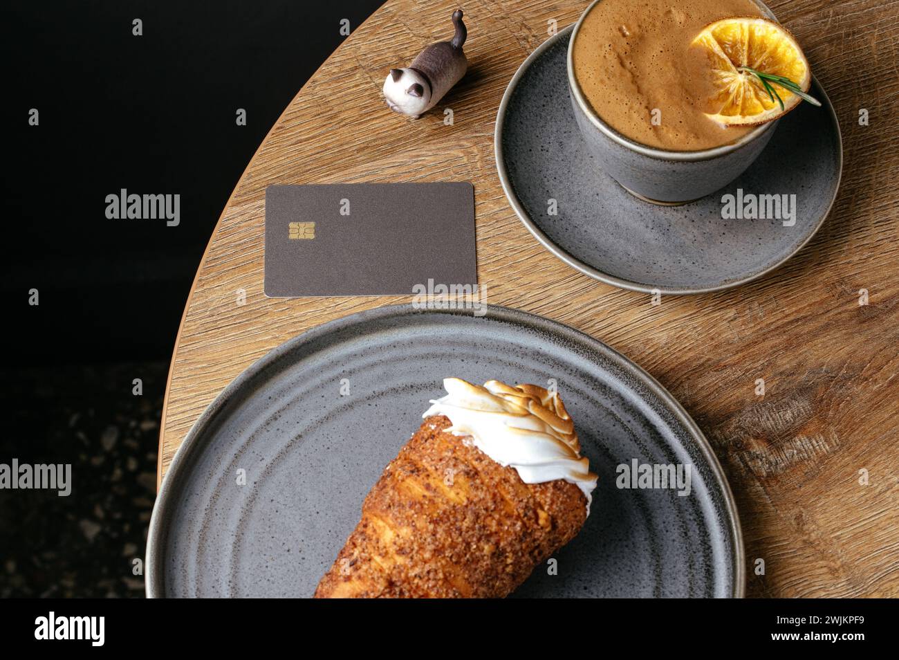 the bank card is on the table in the coffee shop next to the cof Stock ...
