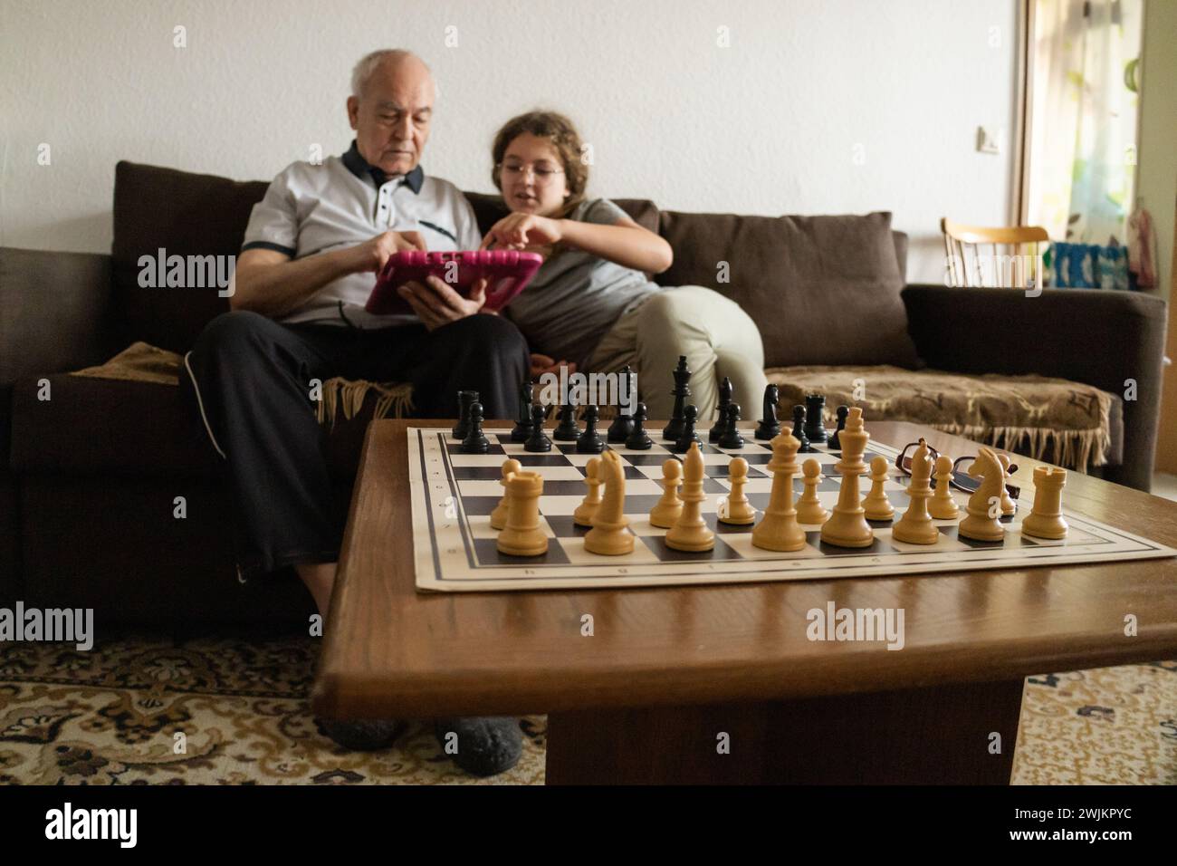 teenage girl visiting her grandfather. two generations Stock Photo - Alamy