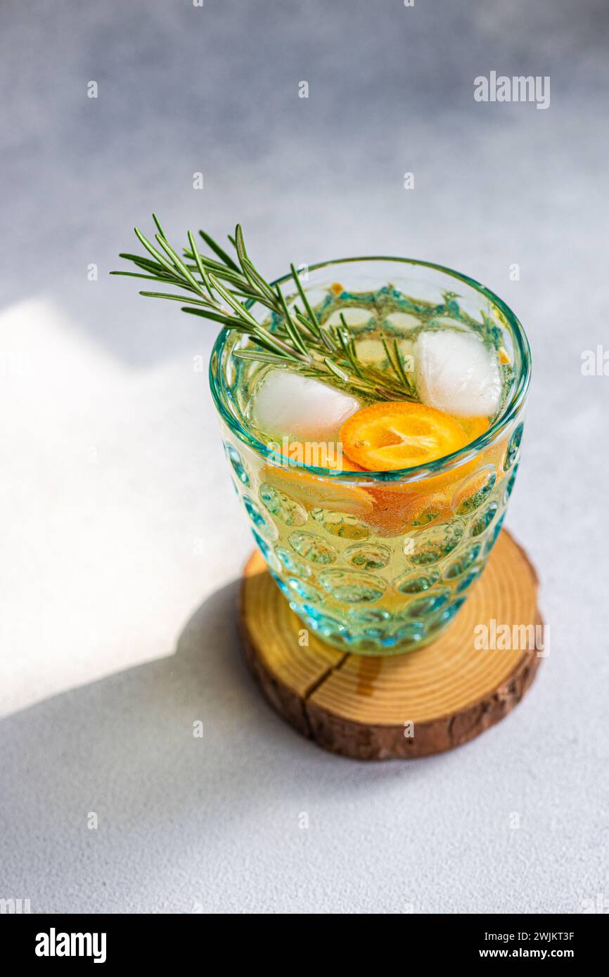 Summer cocktail vodka with tonic and ripe kumquat fruit Stock Photo - Alamy