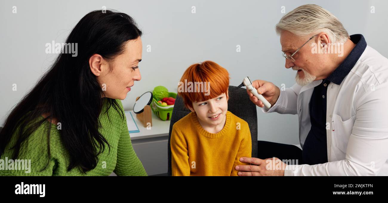 Mother with male child visiting pediatric audiologist for hearing check ...