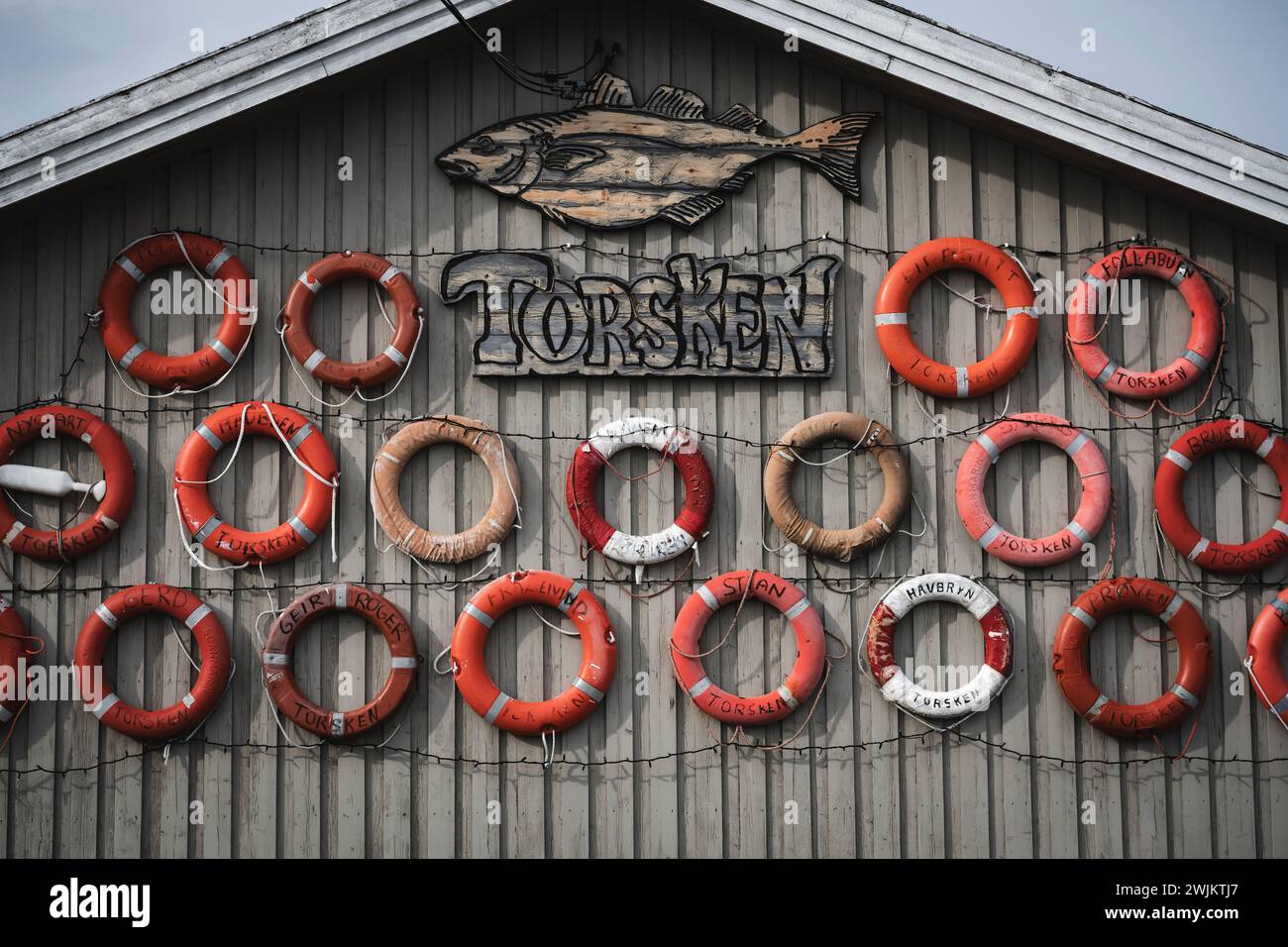 Life belts and logo with text hanging on wall of hut Stock Photo - Alamy
