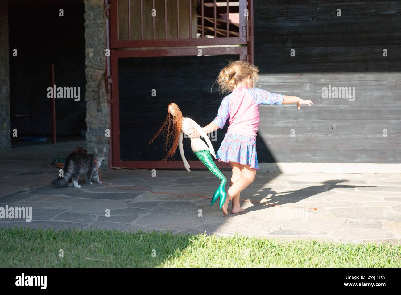 Little Girl Playing with Her Shadow Stock Photo - Alamy