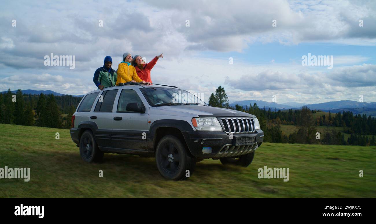 Group of multiethnic tourists together ride on vacation in mountains ...