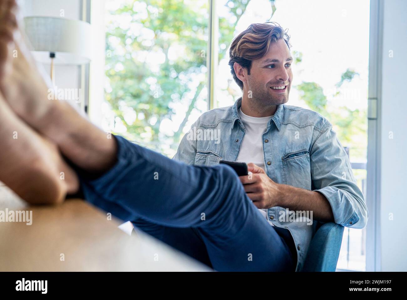 Man barefoot feet table hi-res stock photography and images - Alamy