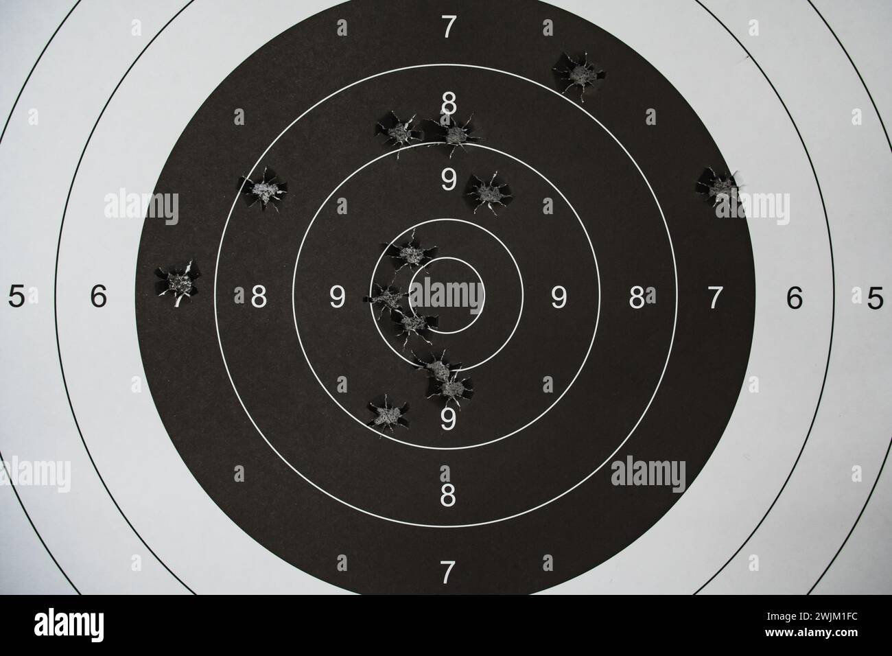 A paper target for shooting with holes from 9mm pistol bullets in the ...