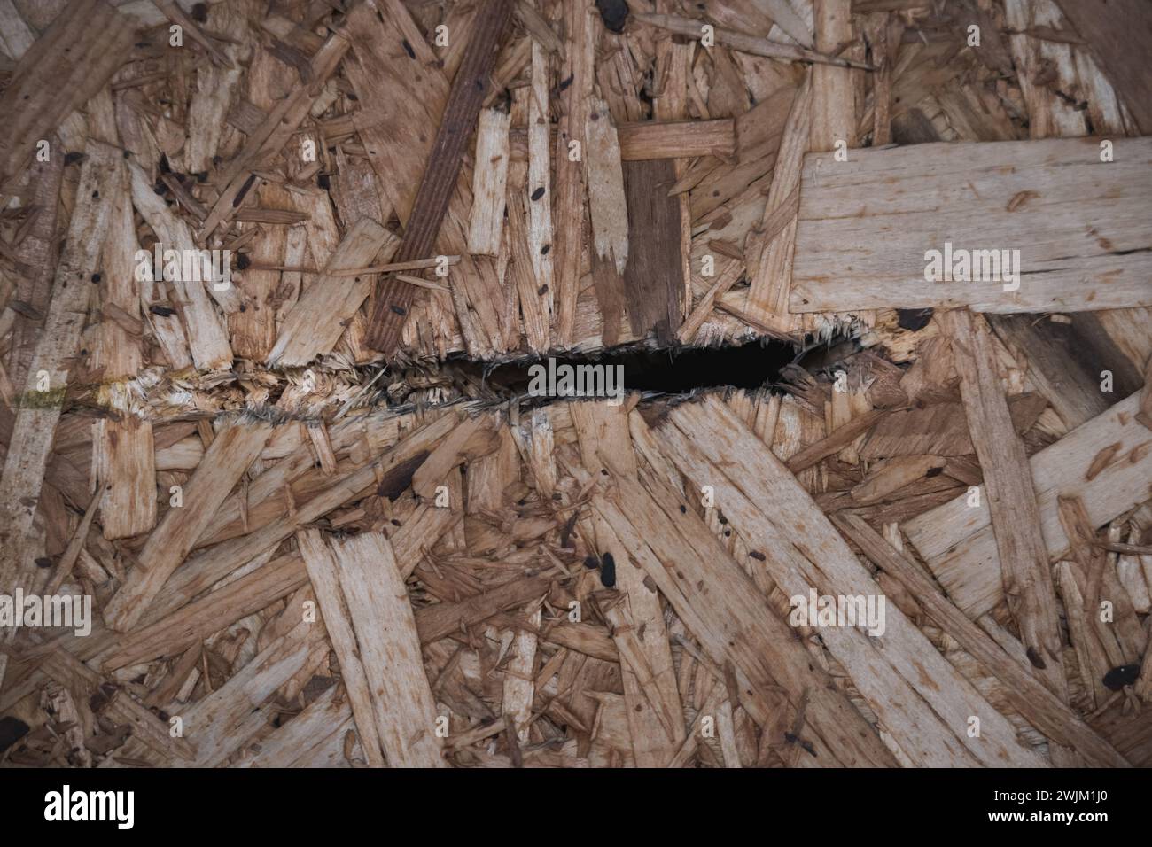 Bullet tangential damage to a chipboard wall at a shooting range, close ...