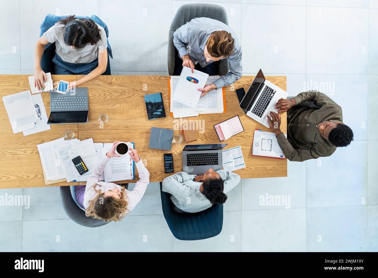 Financial team sitting at desk while working on project Stock Photo - Alamy