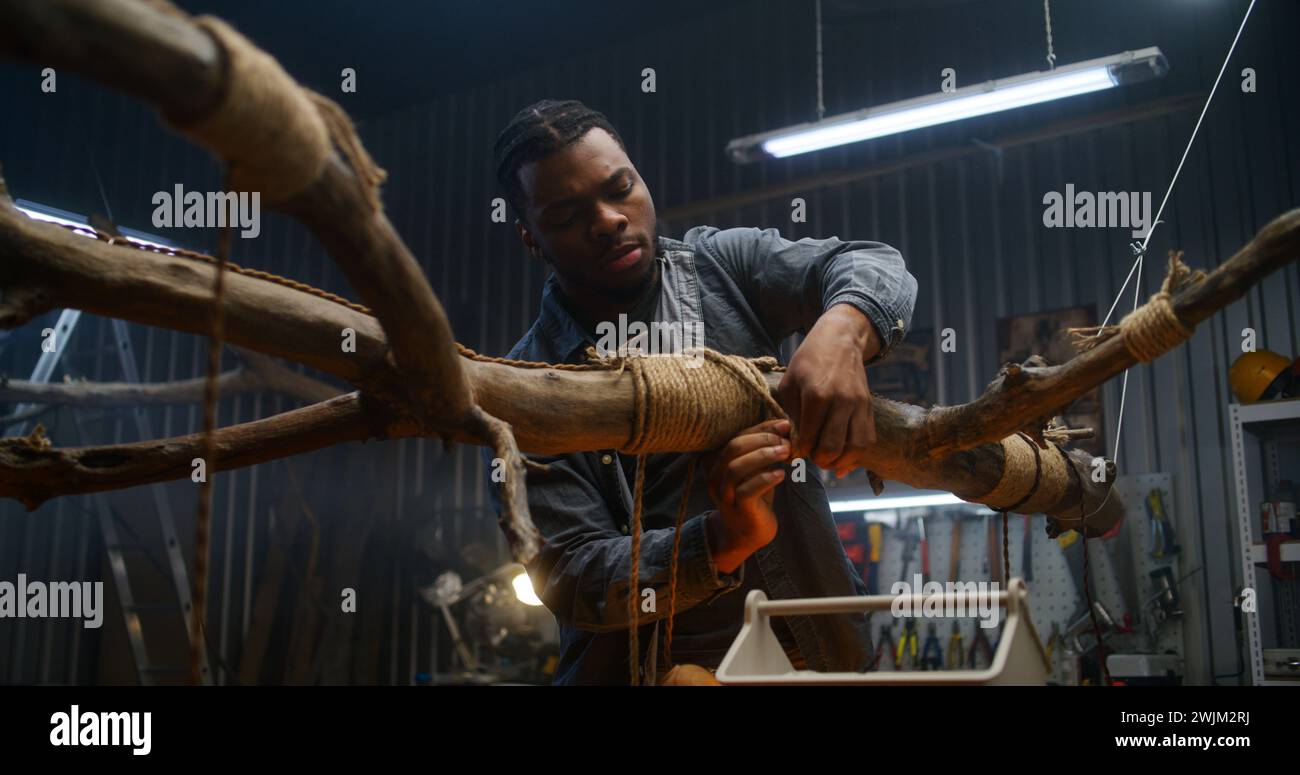 African American carpenter or craftsman creates design wood product ...